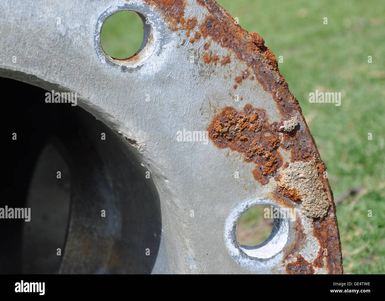 Abstract of large industrial and rusted metal pipe flange with bored ...