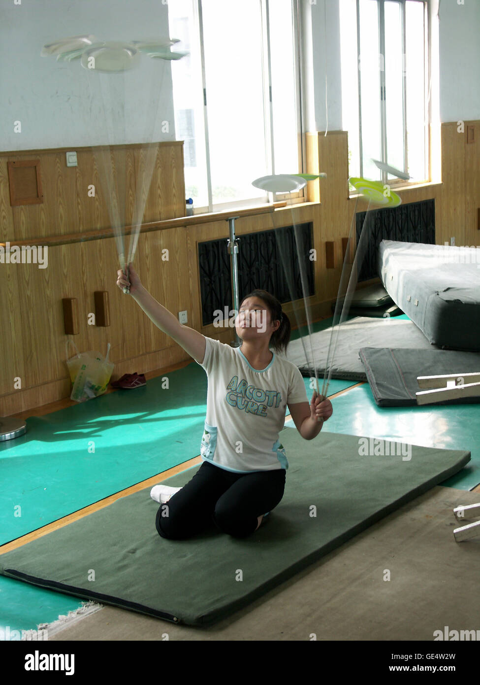 Young girl juggling spinning plates at the Acrobatics Program. Beijing ...