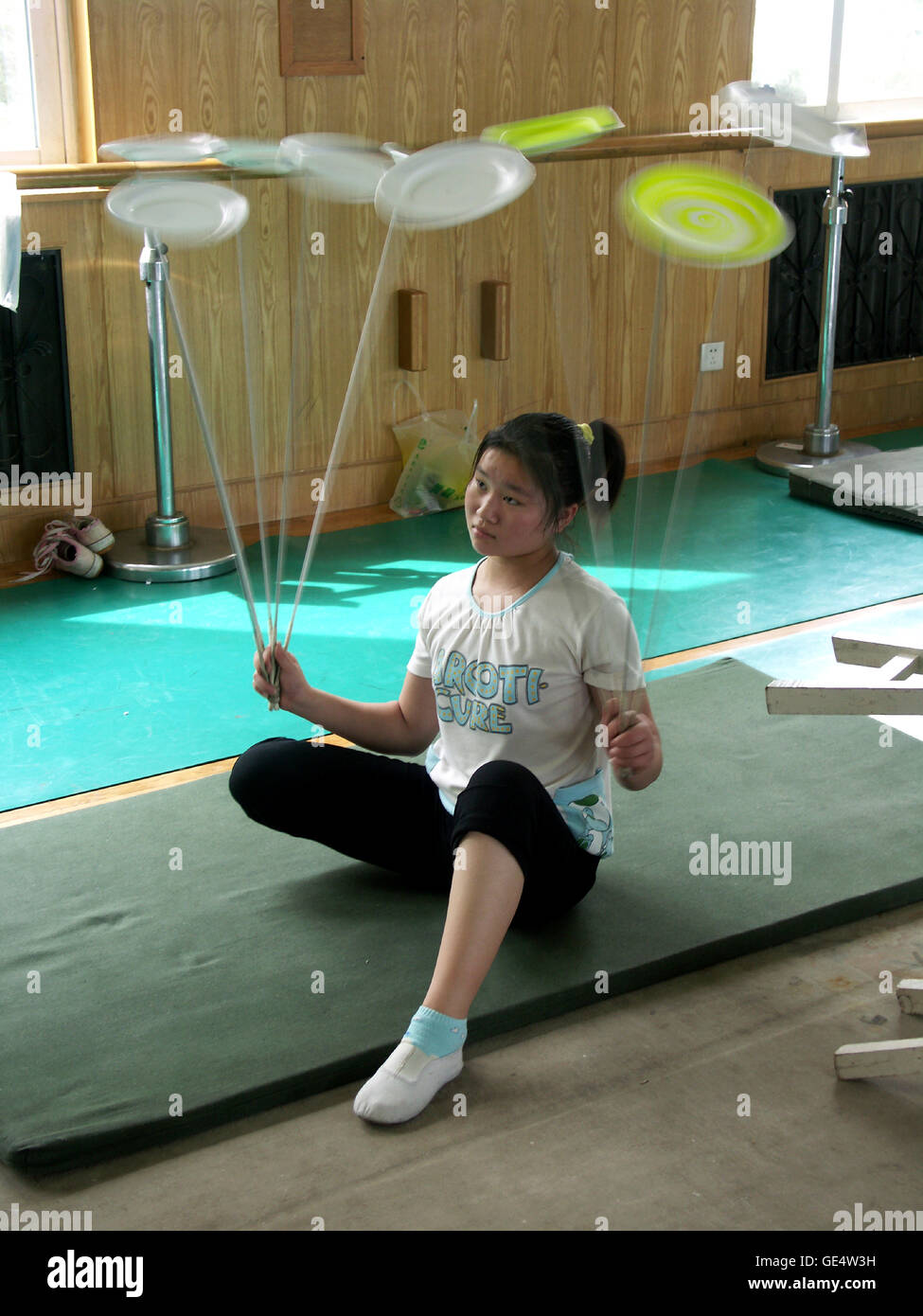 Young girl juggling spinning plates at the Acrobatics Program. Beijing ...