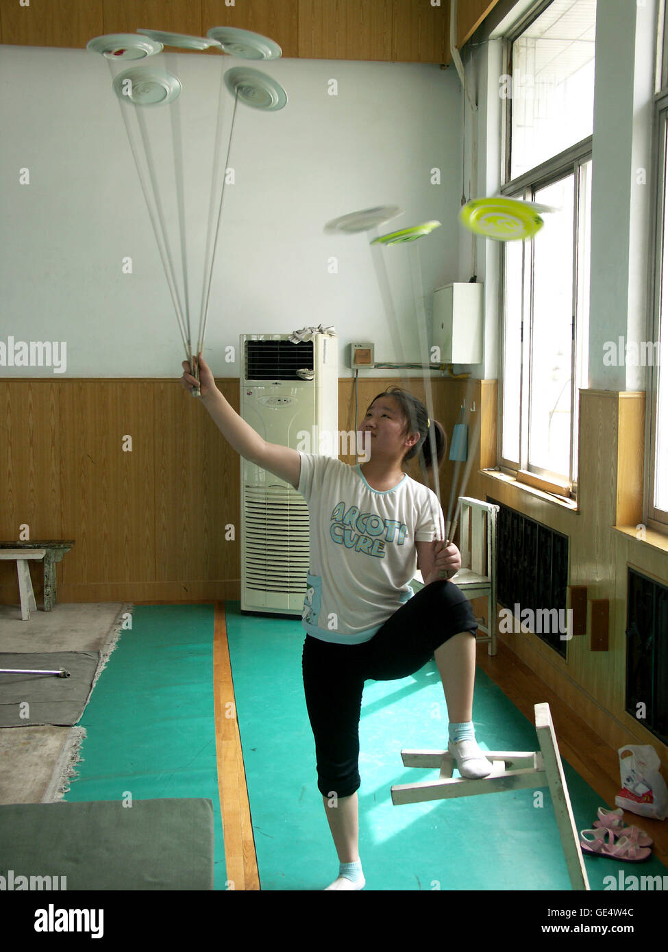 Young girl juggling spinning plates at the Acrobatics Program. Beijing ...