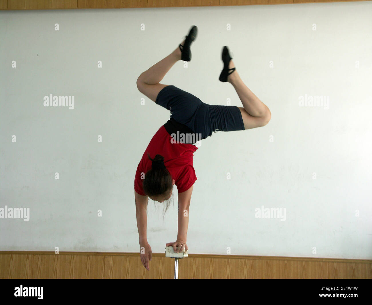 Young girl doing a one-handed handstand at the Acrobatics Specialty ...
