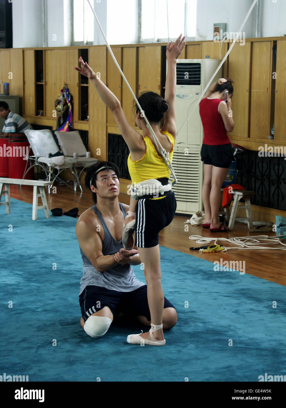 Coach and acrobat practicing a stunt at the Acrobatics Specialty ...