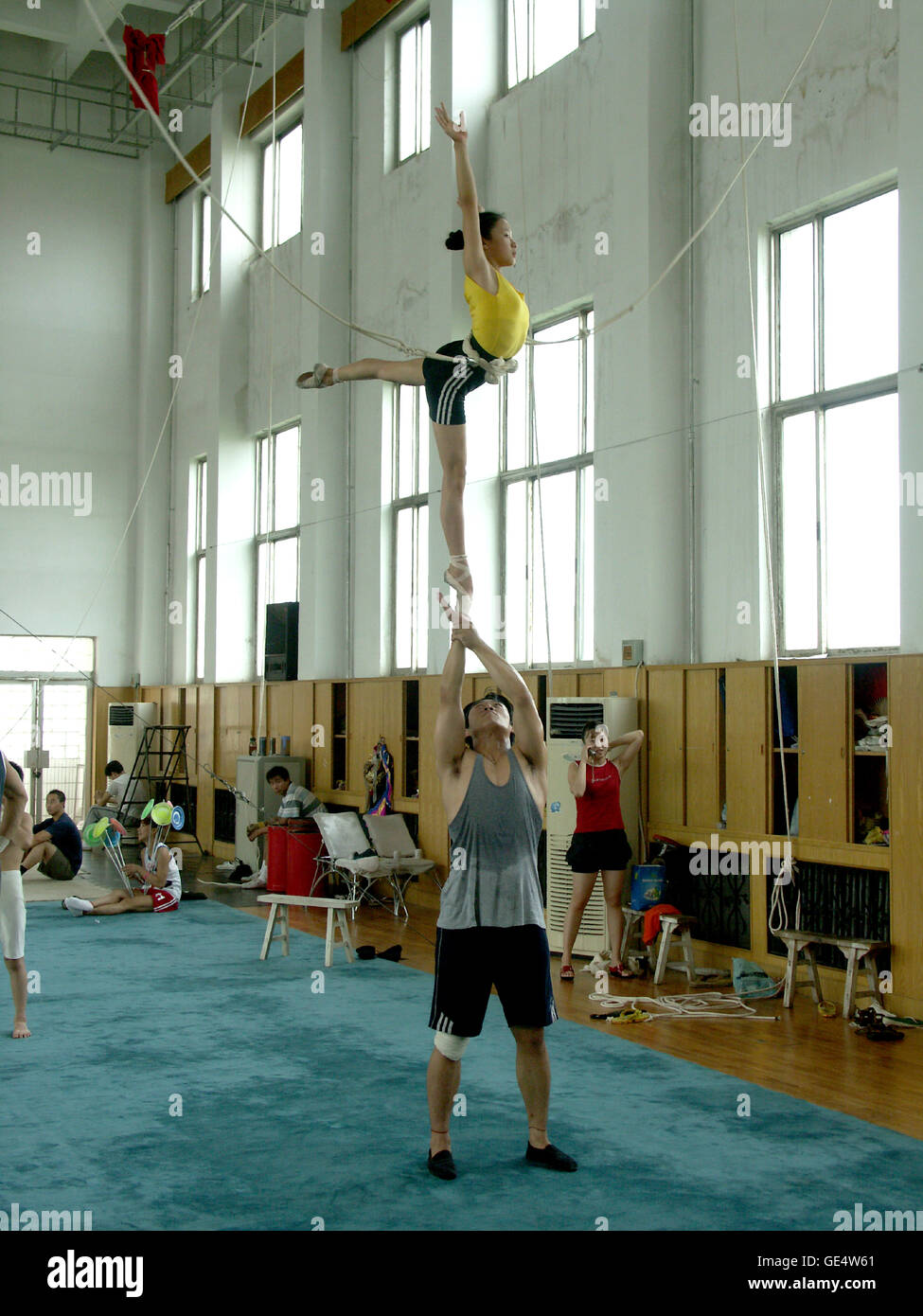 Coach and acrobat practicing a stunt at the Acrobatics Specialty ...