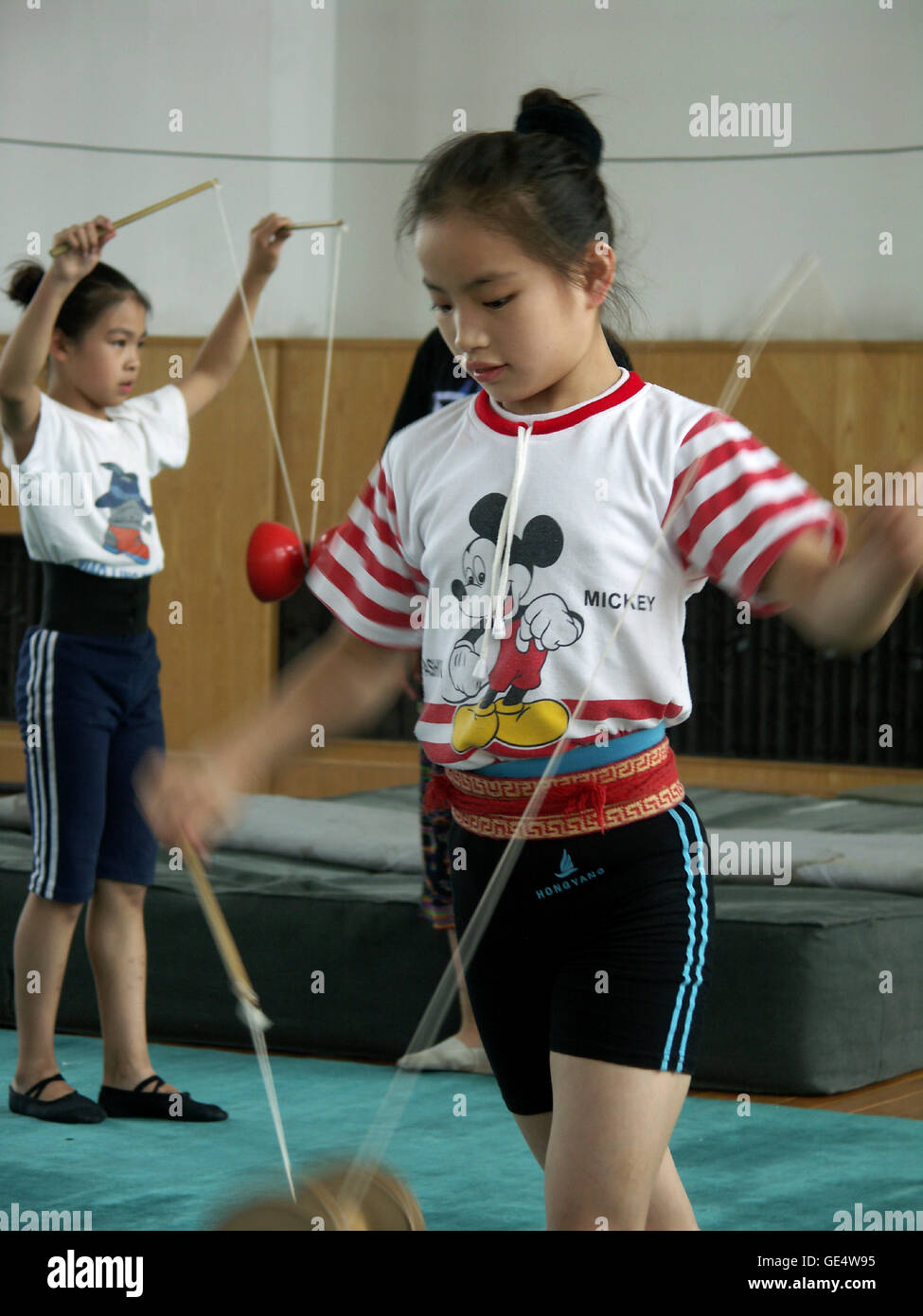 Young girl practicing juggling a cup on a rope at the Acrobatics ...