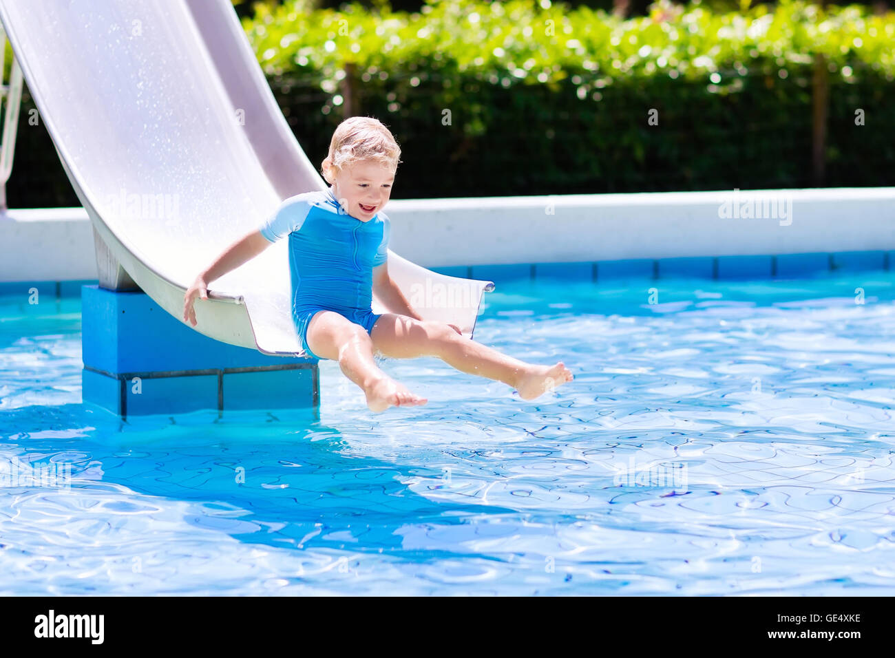 Happy kids playing on slide hi-res stock photography and images - Alamy