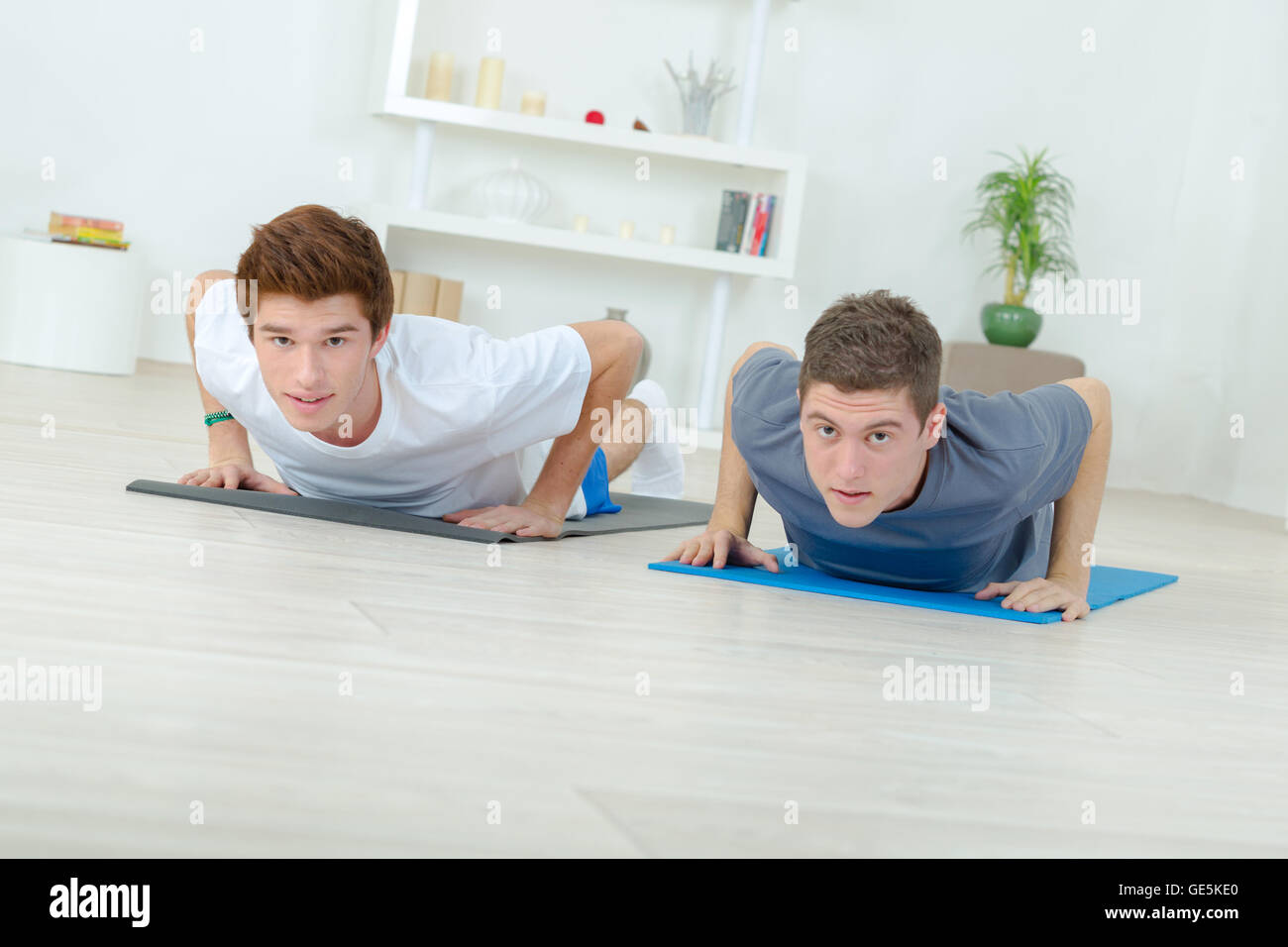 Two men doing push-ups Stock Photo - Alamy