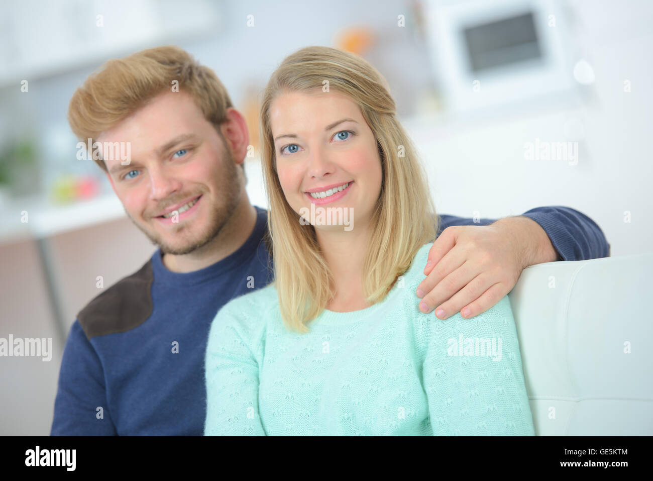 Couple hugging on the sofa Stock Photo - Alamy