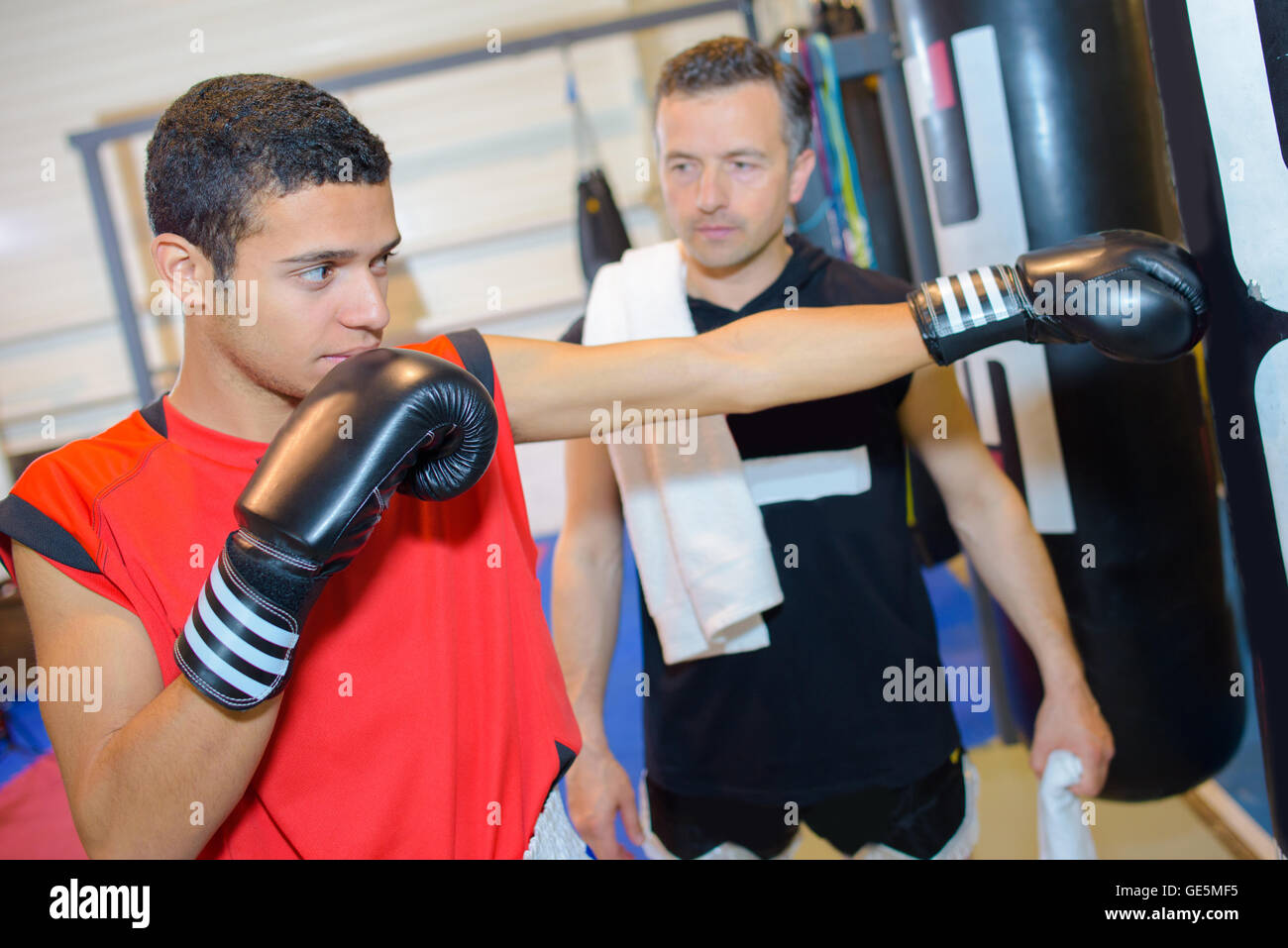 Young man in boxing training with instructor Stock Photo - Alamy