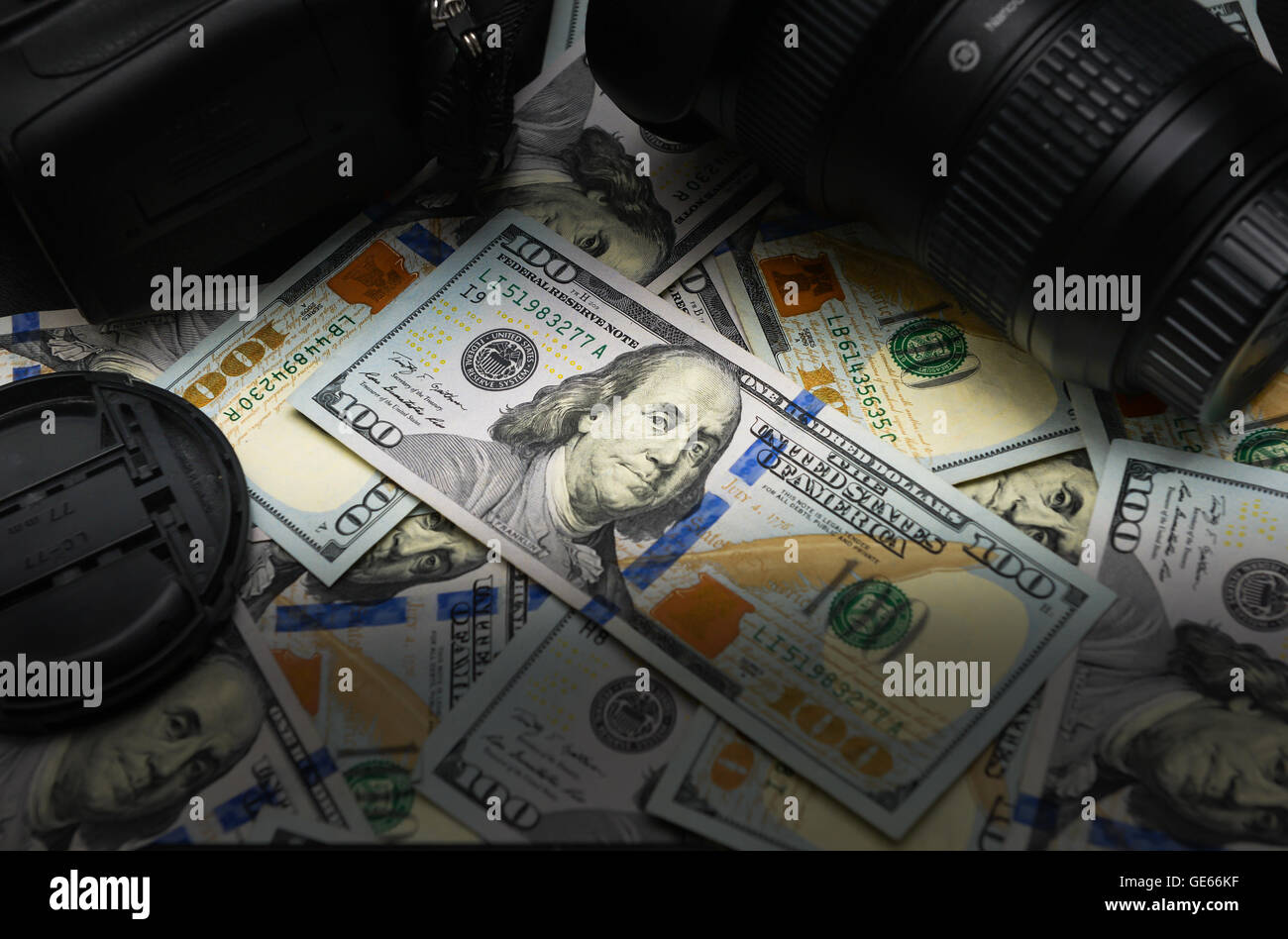 Background American one hundred dollar bills and DSLR camera devices ...