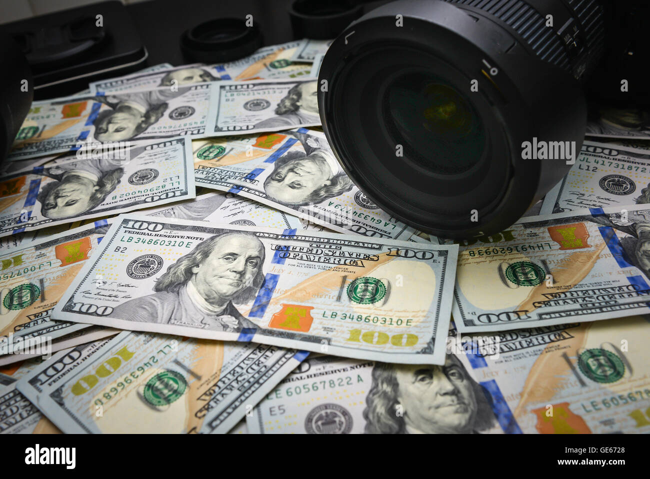 Background American one hundred dollar bills and DSLR camera devices ...