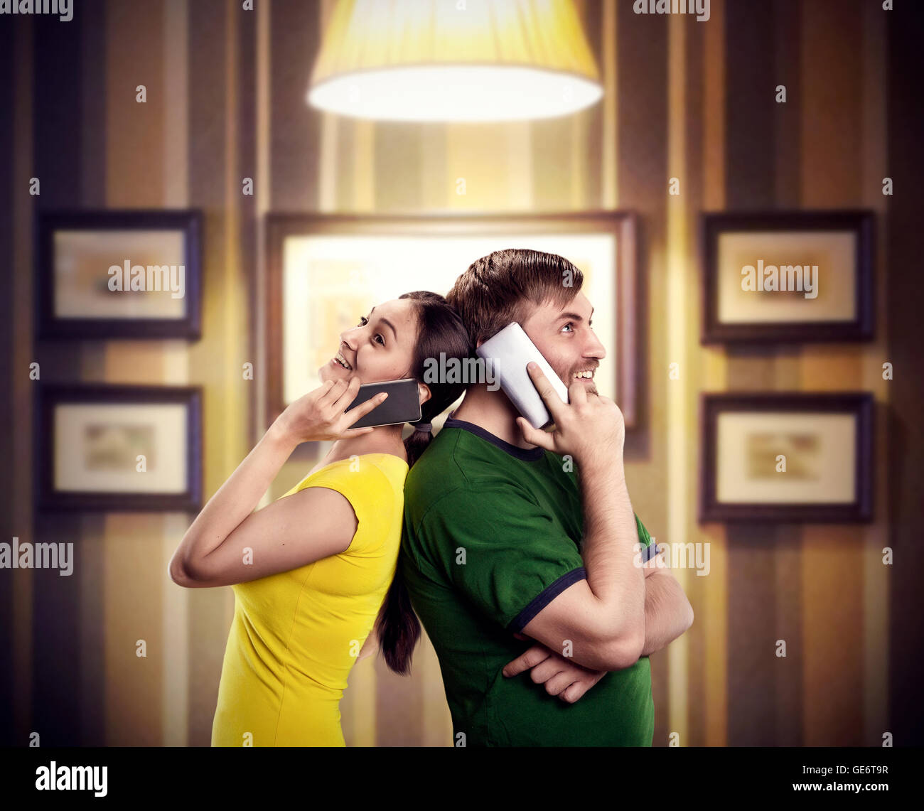 Happy couple talking by phones Stock Photo - Alamy