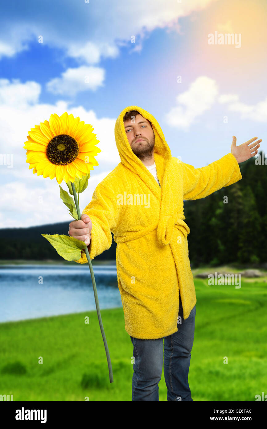 Man in the monitor holding a sunflower Stock Photo - Alamy