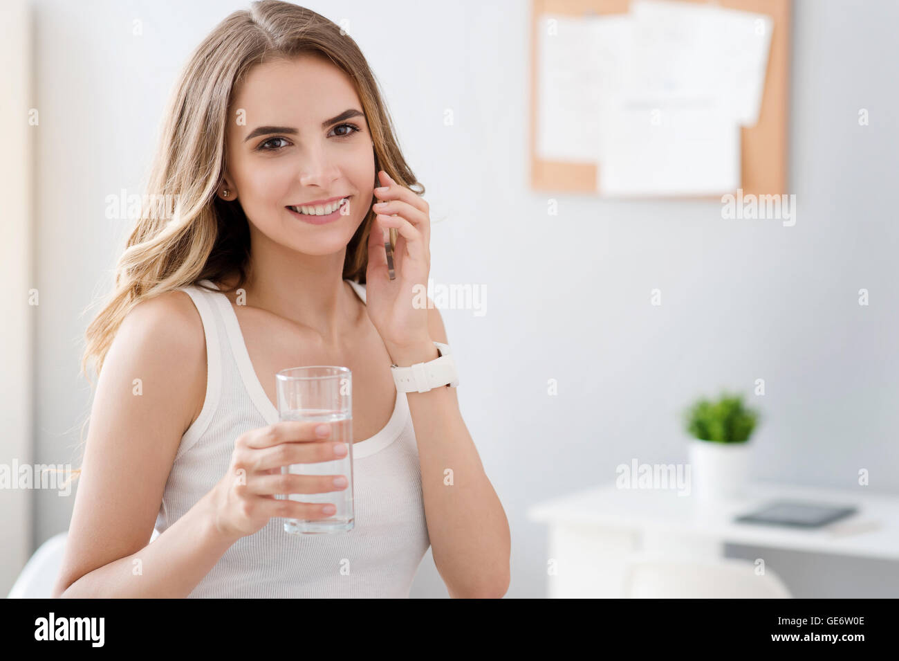 Delighted smiling woman drinking water Stock Photo - Alamy