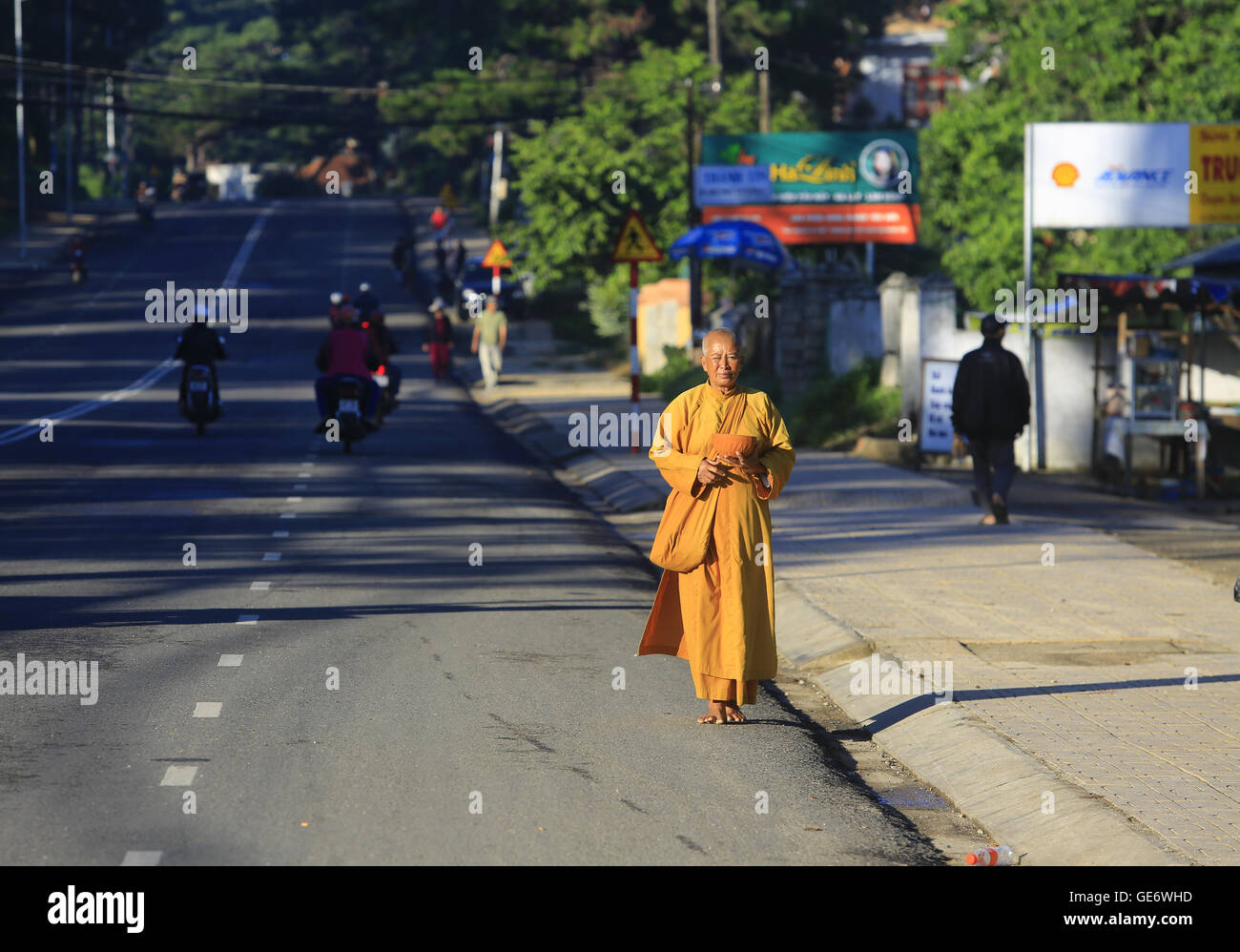 Walking monk on street in morning Stock Photo - Alamy