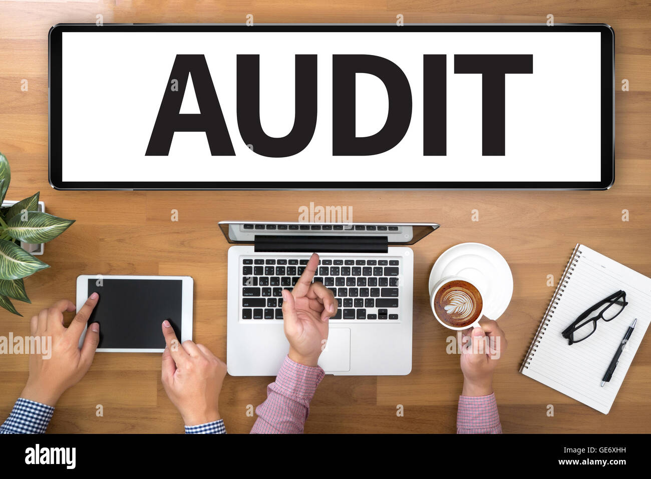 AUDIT Two Businessman working at office desk and using a digital touch ...