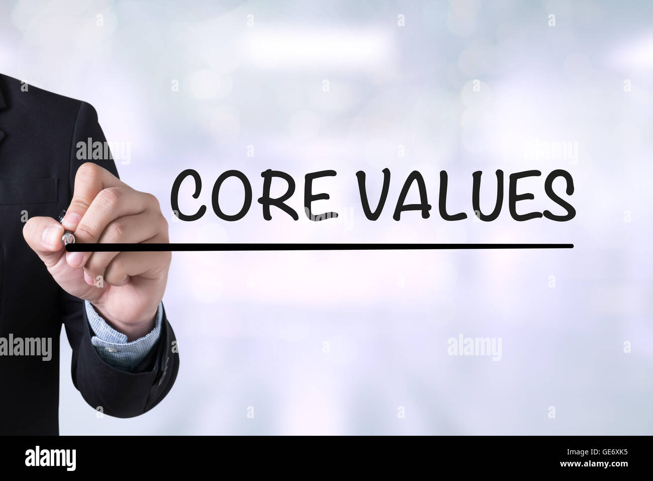 CORE VALUES Businessman drawing Landing Page on blurred abstract ...