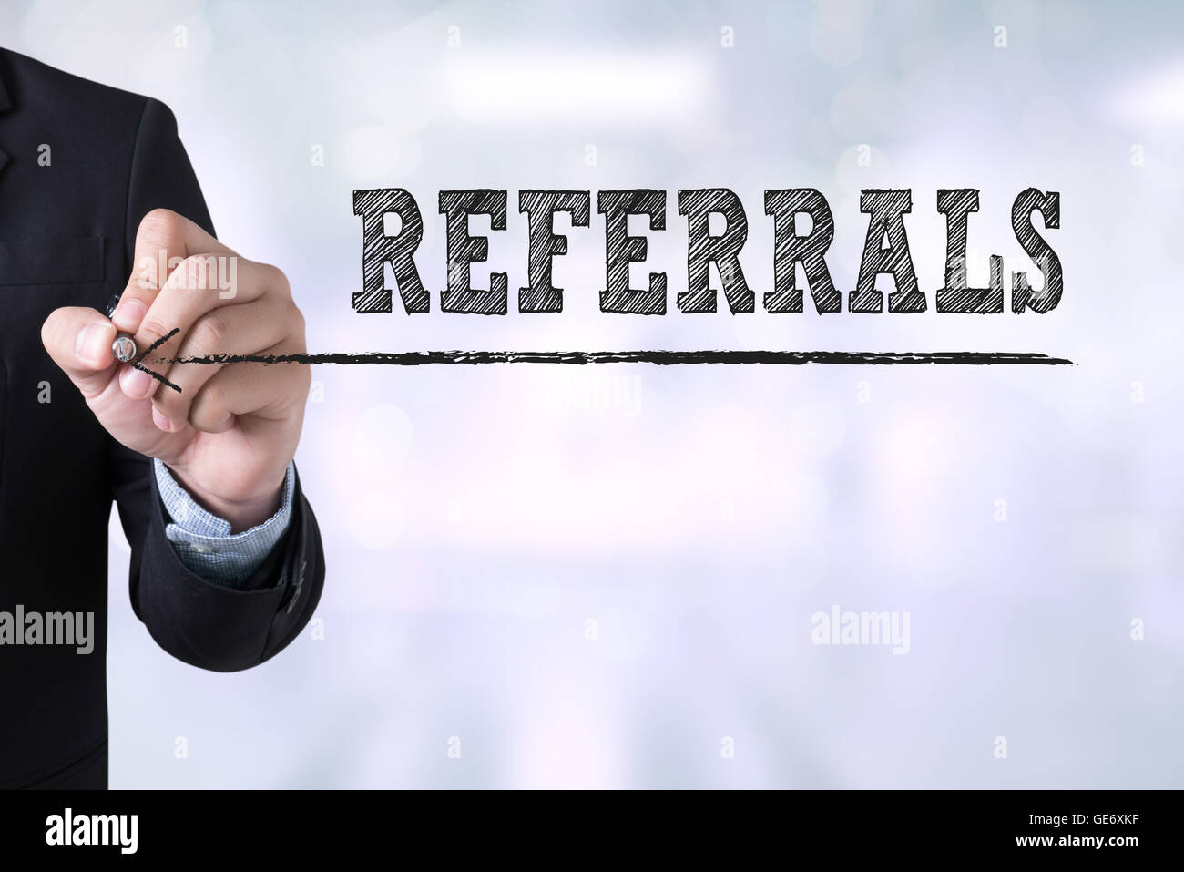 REFERRALS Businessman drawing Landing Page on blurred abstract ...