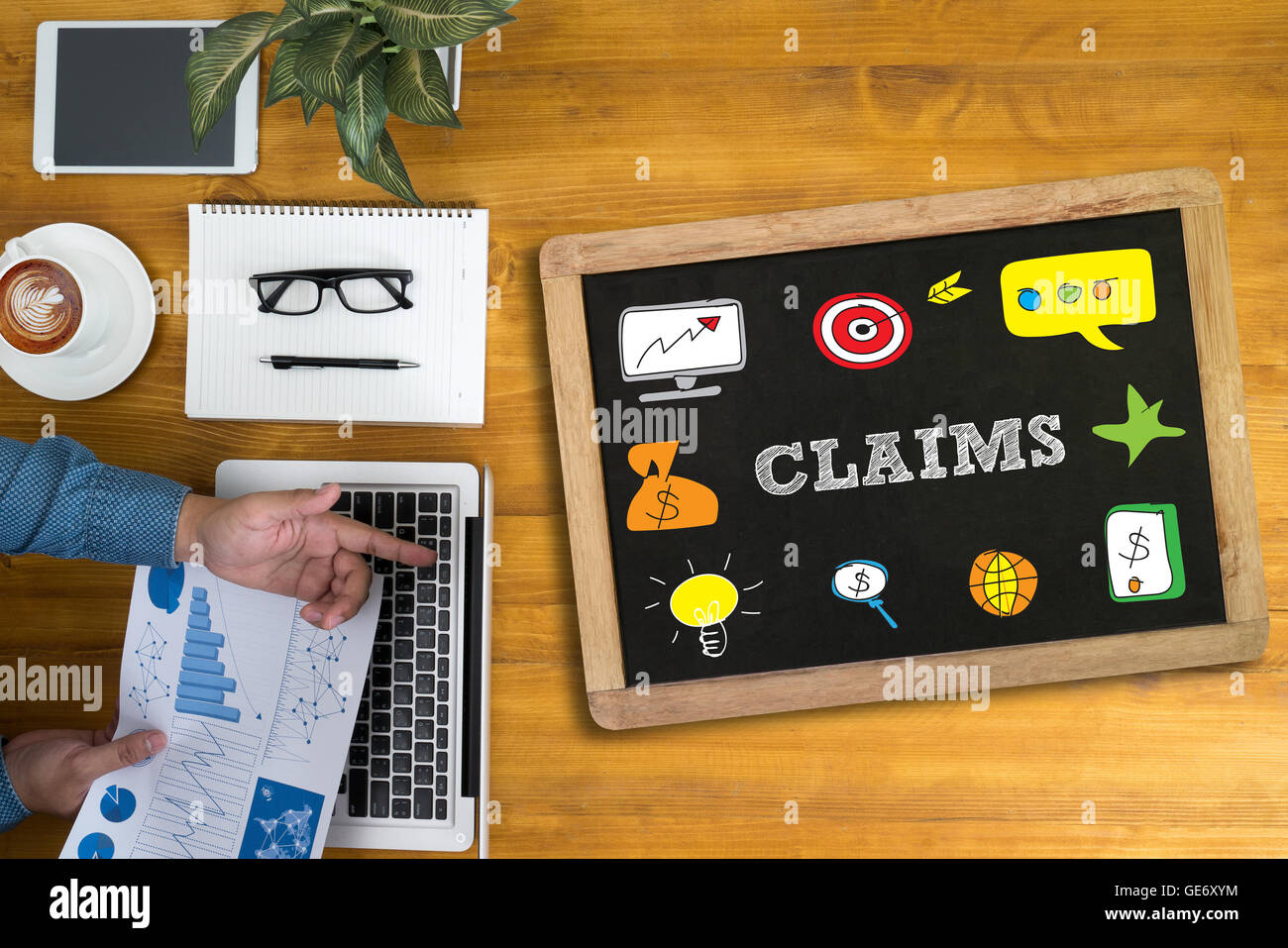 CLAIMS CONCEPT Businessman working at office desk and using computer ...