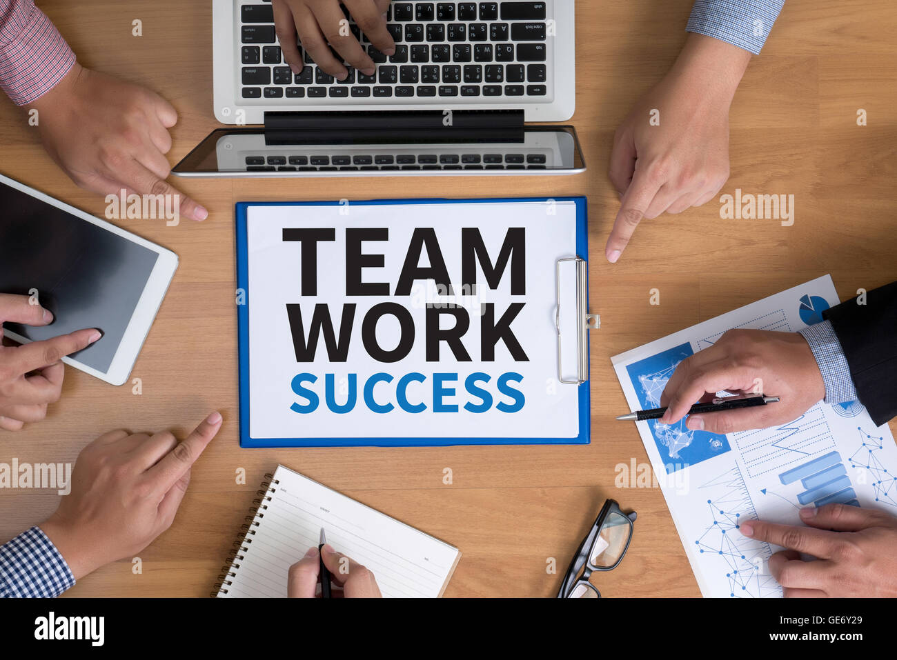 TEAMWORK SUCCESS CONCEPT Business team hands at work with financial ...