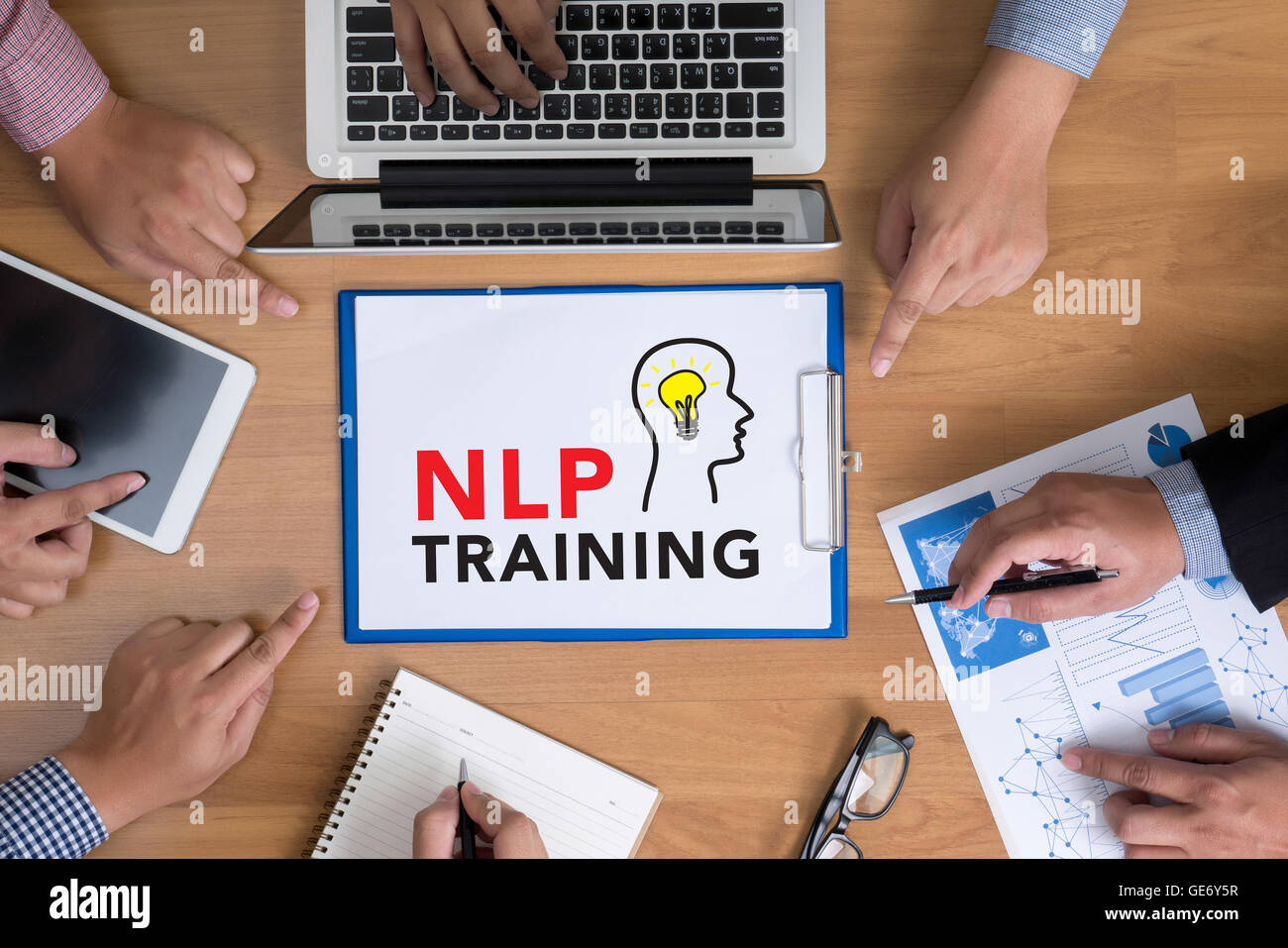 NLP TRAINING CONCEPT Business team hands at work with financial reports ...