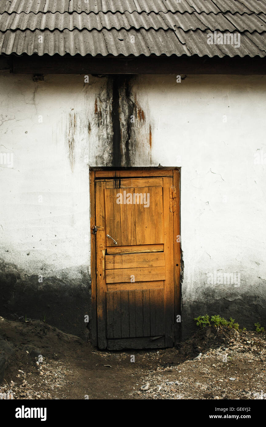 Old abandoned house with wooden door Stock Photo - Alamy
