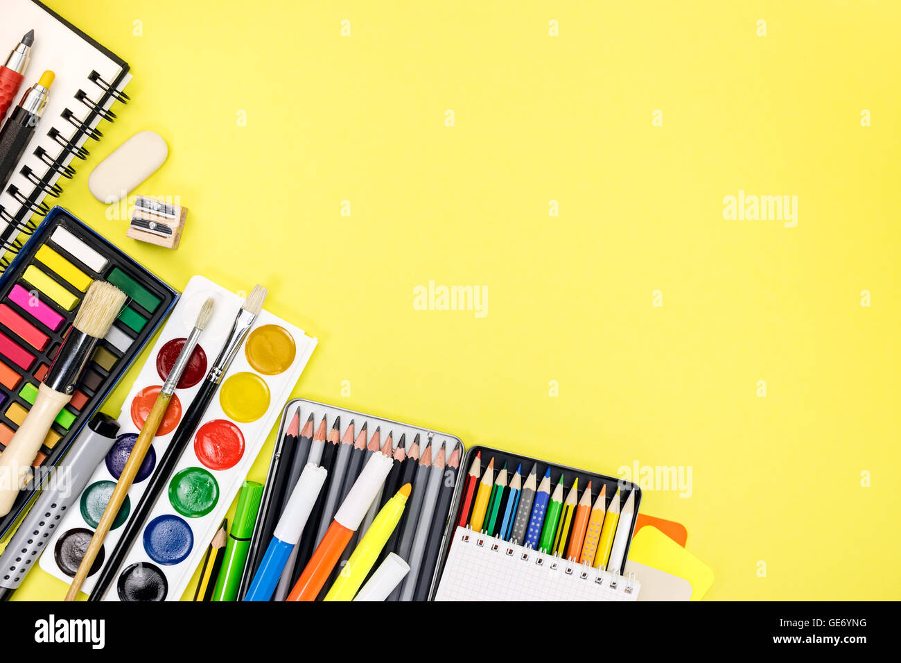 yellow writing desk with colorful stationary and office supplies for ...