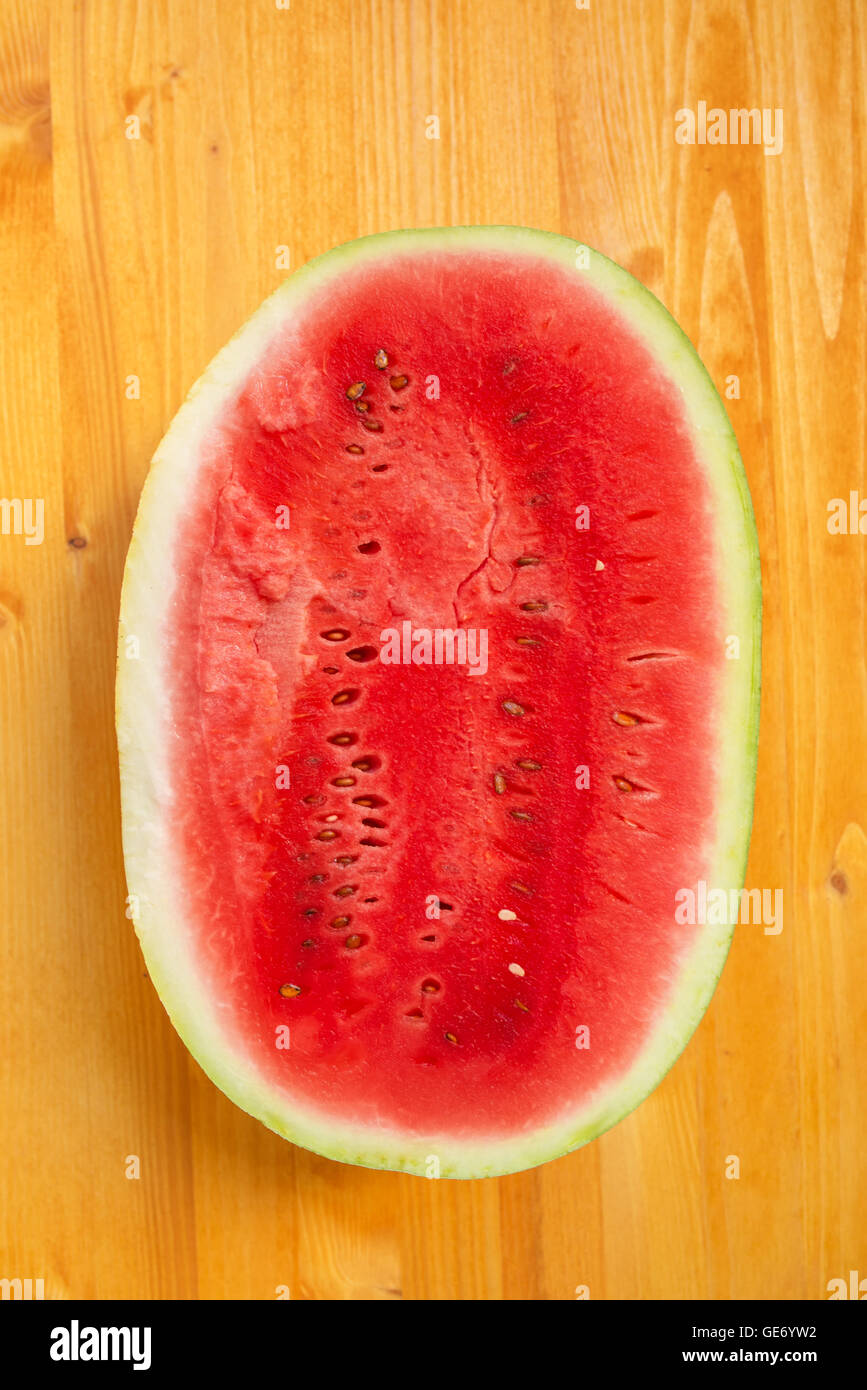 Watermelon cross section slice on wooden table, top view selective ...