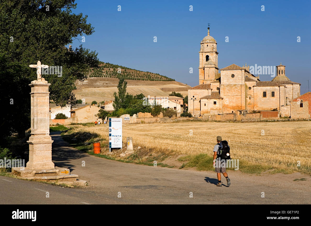 Pilgrim, cross and Colegiata de Santa María del Manzano.Castrojeriz ...