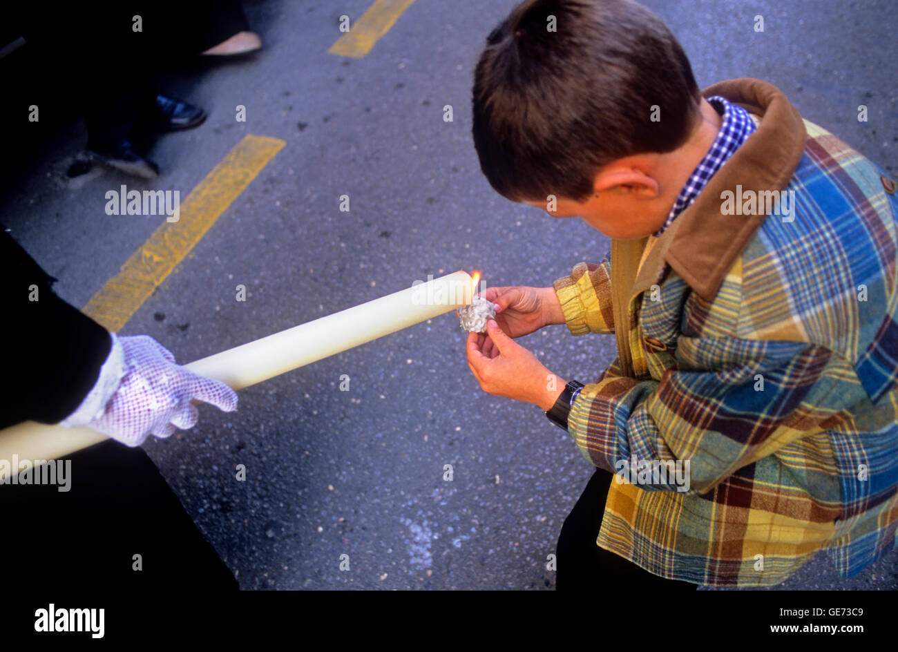 Penitent and boy.Boy making a ball of wax.Brotherhood of `Resucitado de ...