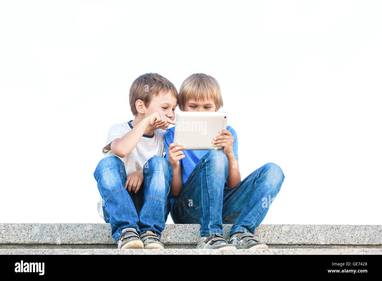 Children playing outdoor with tablet PC. People education learning ...
