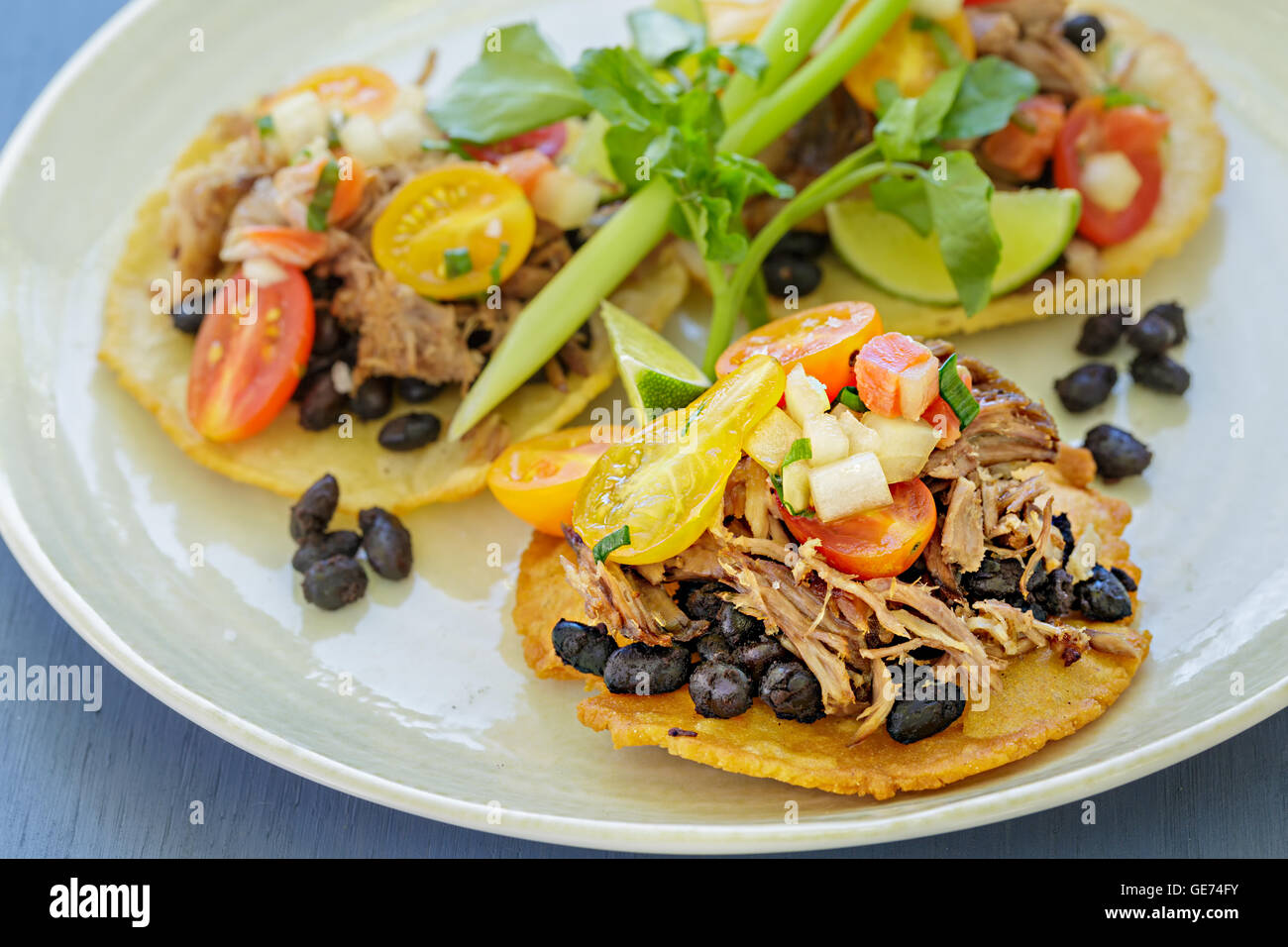 Mini tostadas with crispy pork, black beans and pico de gallo Stock ...