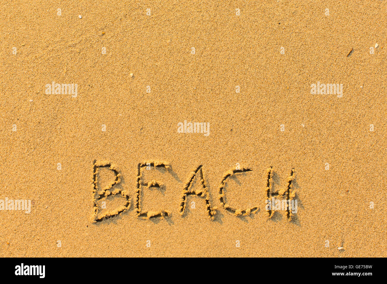 Beach - words hand-written on sand beach Stock Photo - Alamy
