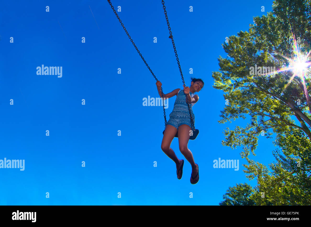 Girl on swing in tree hi-res stock photography and images - Alamy