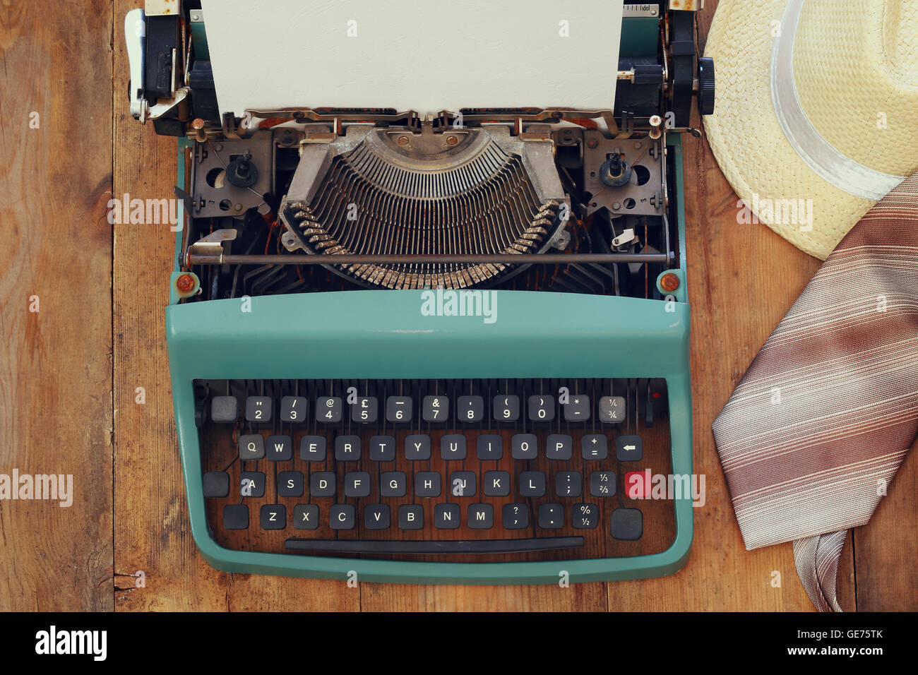 Top view photo of vintage typewriter with blank page next to man ...