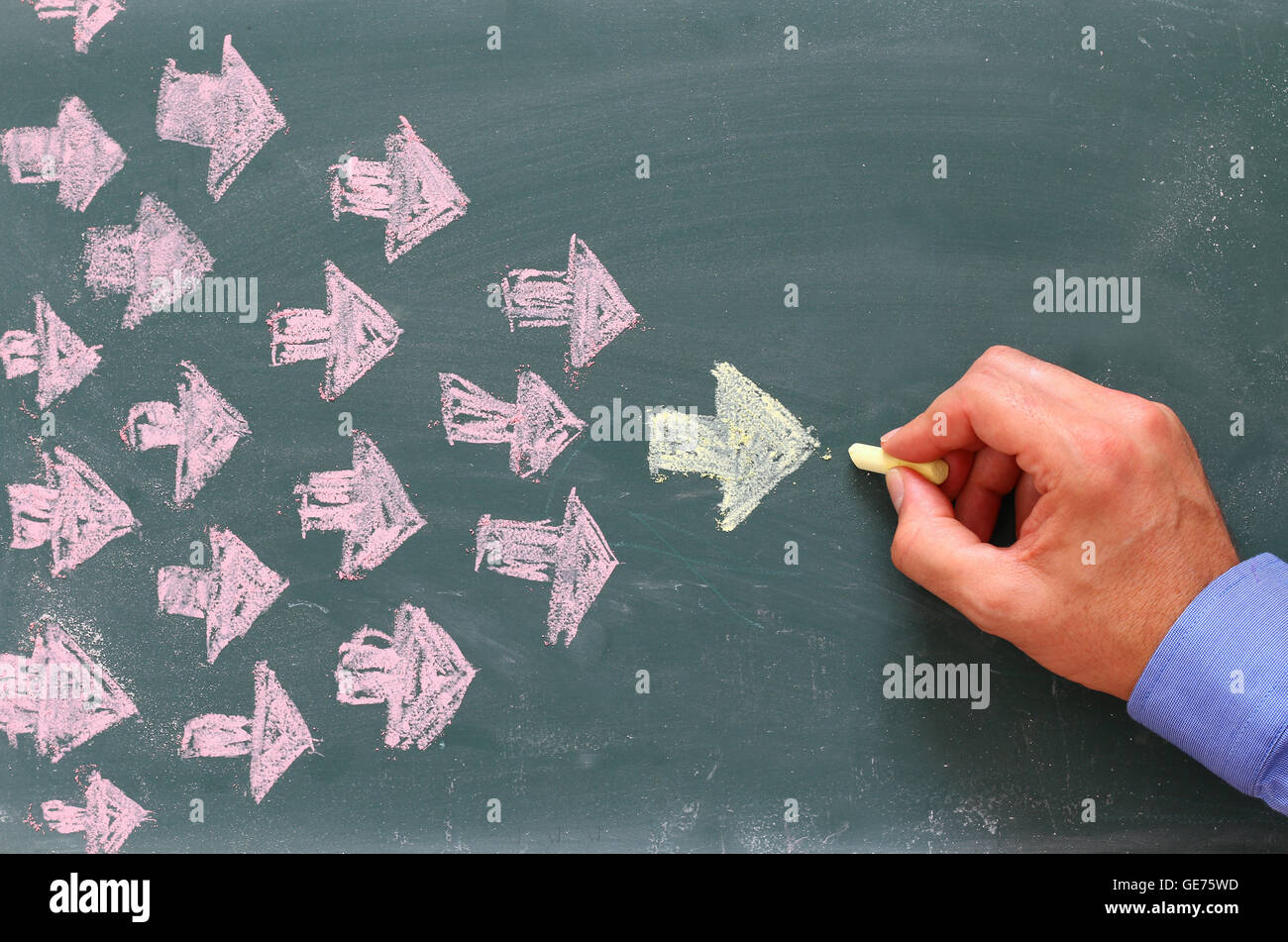 Leadership Concept image, male hand drawing arrows over chalkboard ...