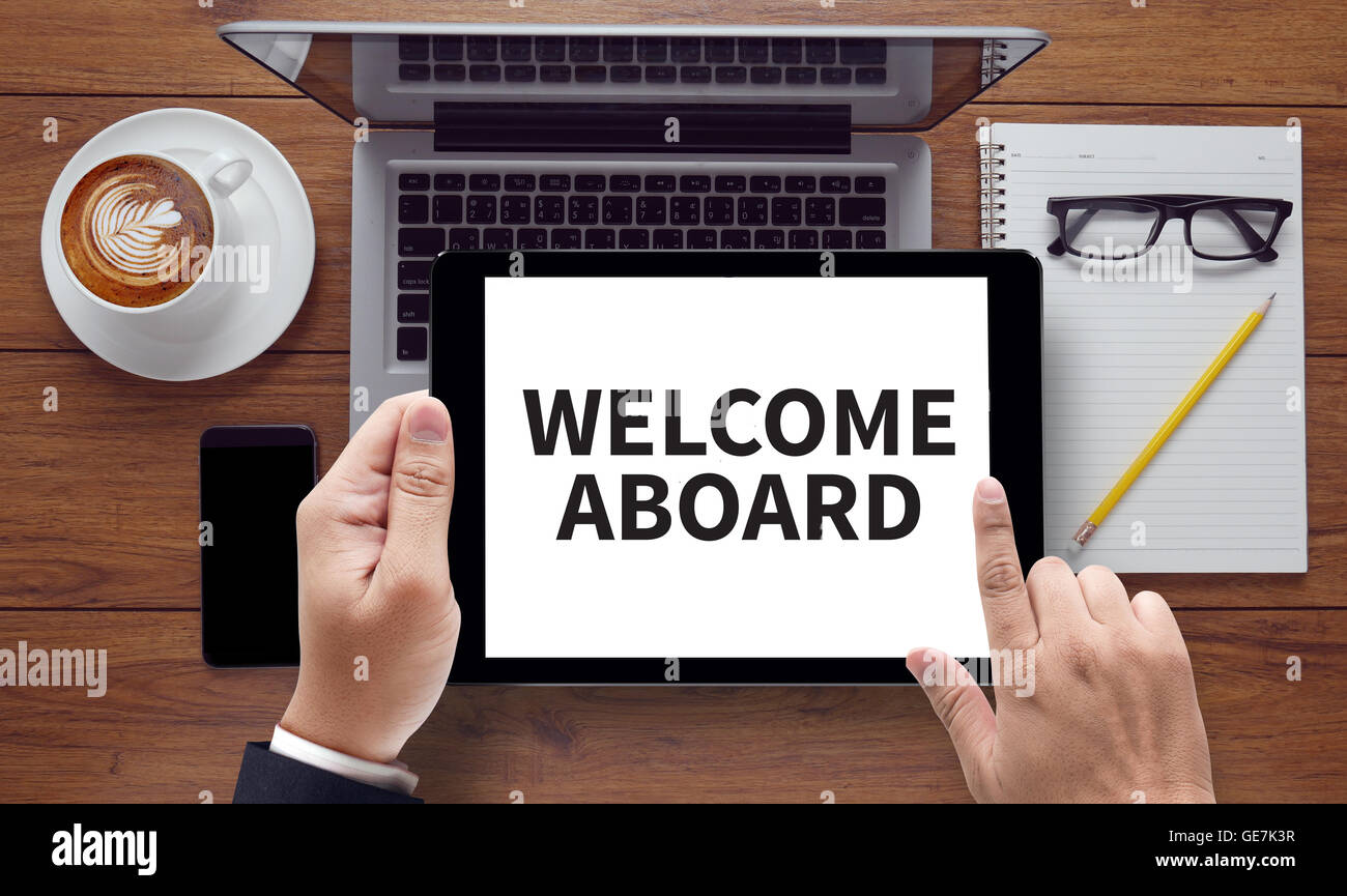 WELCOME ABOARD, on the tablet pc screen held by businessman hands ...