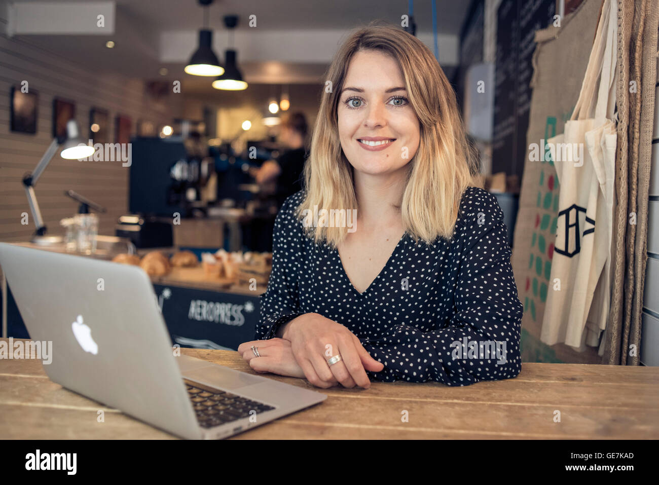 woman working on laptop in a coffee shop using the wifi in the modern ...