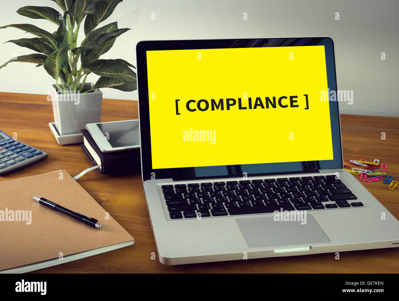 Compliance Concept Laptop screen on table. Warm tone Stock Photo - Alamy