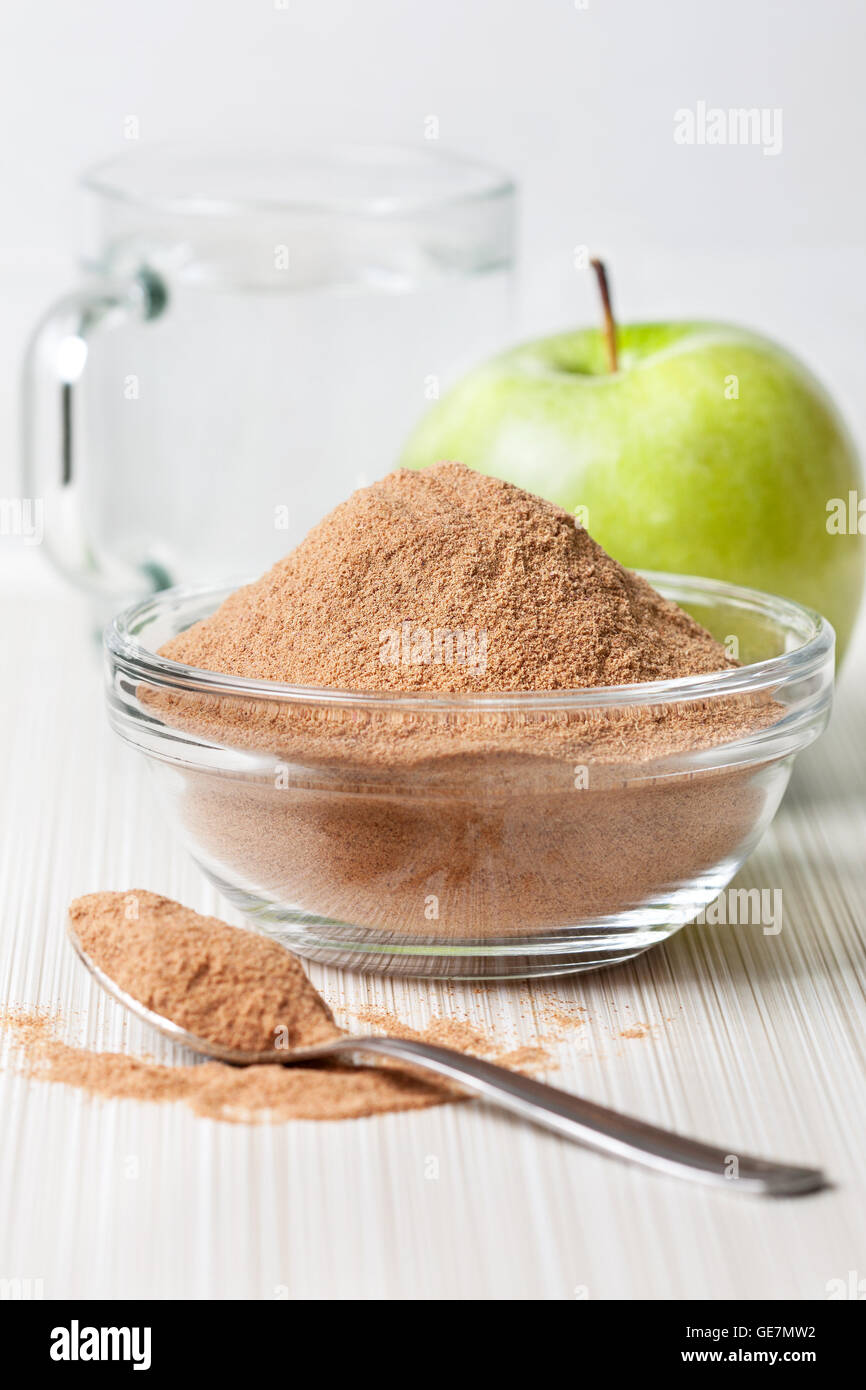 crushed apple fiber, green apple on a light background. dietary product ...