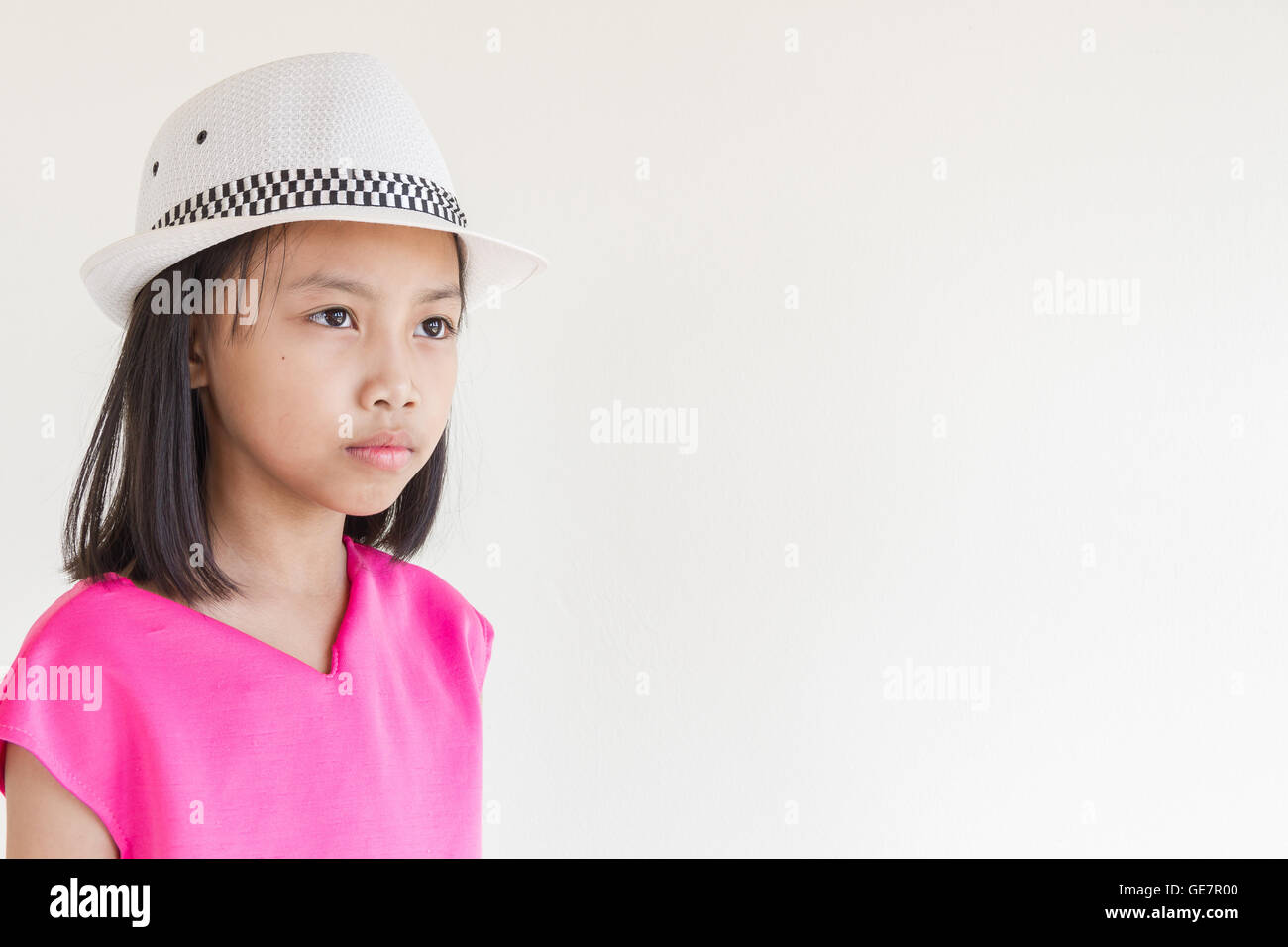 Adorable asian kids in a pink dress with white hat looking for ...