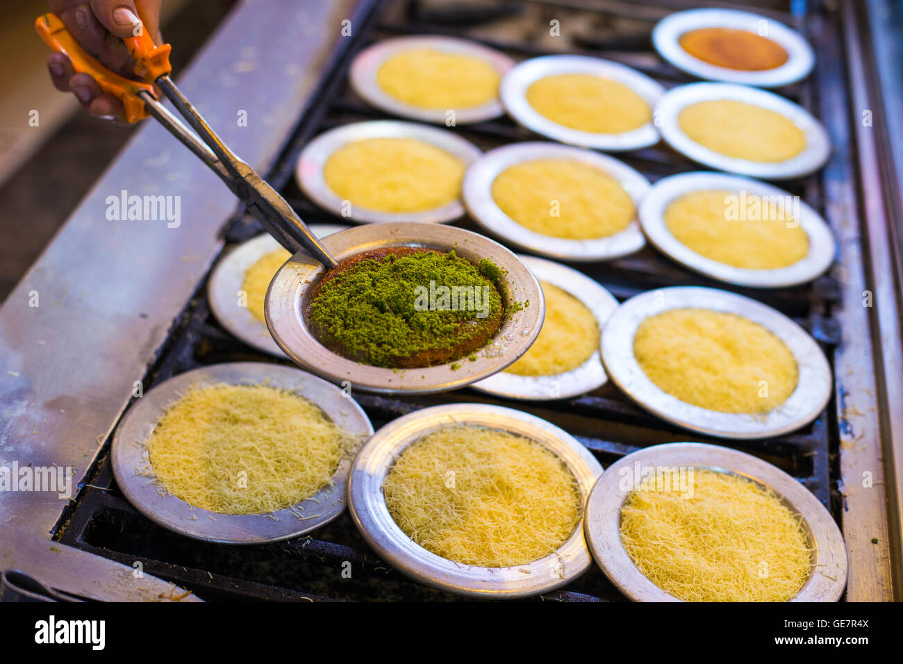 Chef cooking traditional Turkish delicious dessert Kunefe and show ...