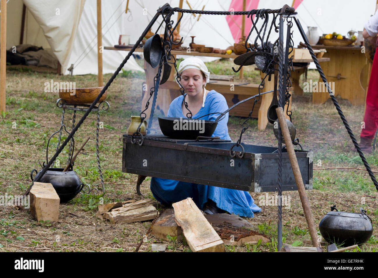 medieval woman reenactor cooking on an open fire Stock Photo - Alamy