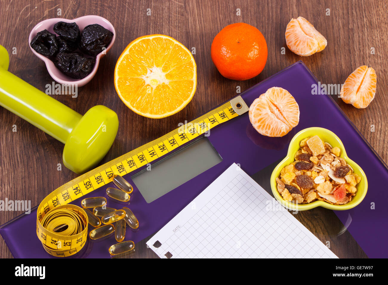 Tape measure, tablets supplements on digital bathroom scale for weight ...