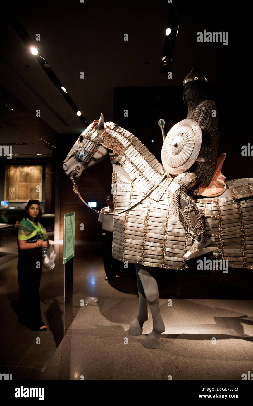 A visitor looking at a display of horse armour at the Museum of Islamic ...