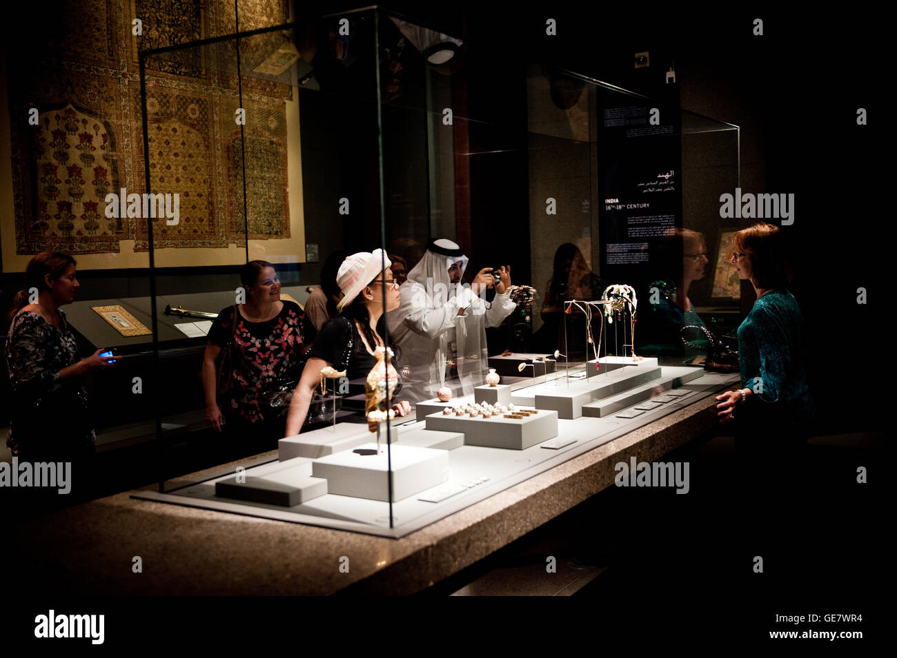Visitors looking artifacts on display at the Museum of Islamic Art in ...
