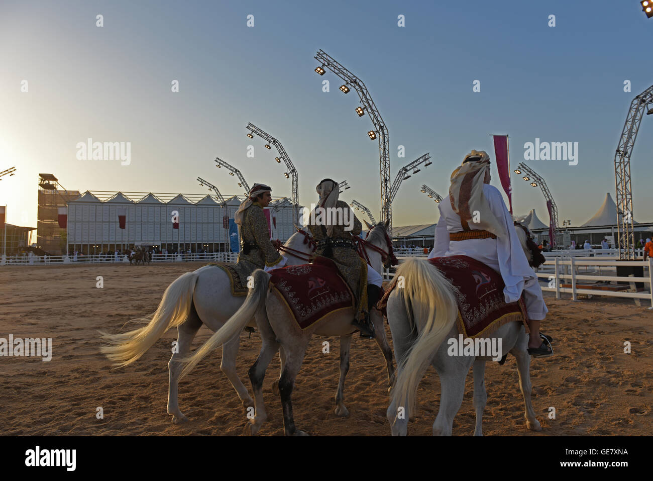 Qatari men riding horses in Dar Alsaaii Stock Photo - Alamy