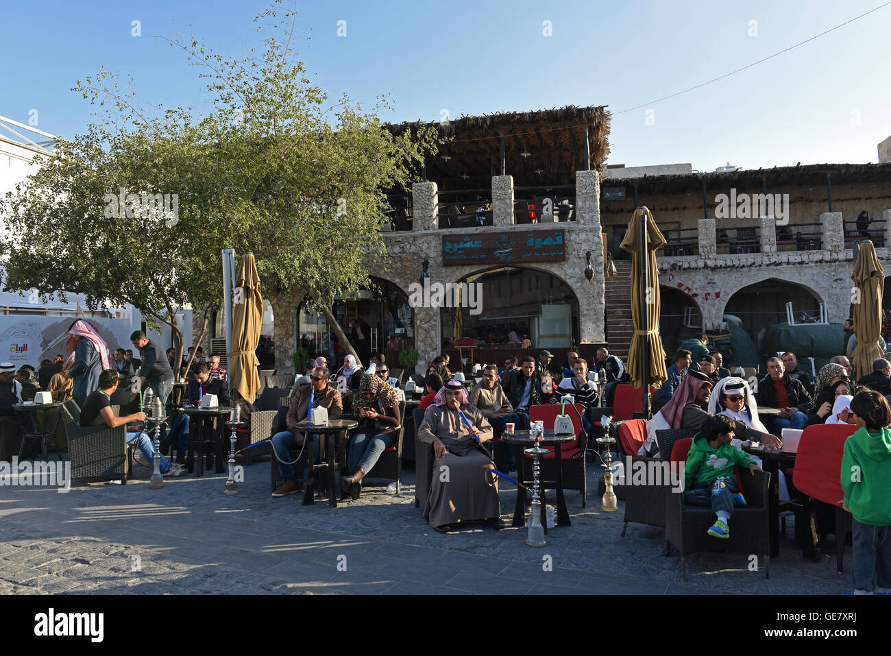 People smoking shisha at winter festival in Souq Waqif Stock Photo - Alamy