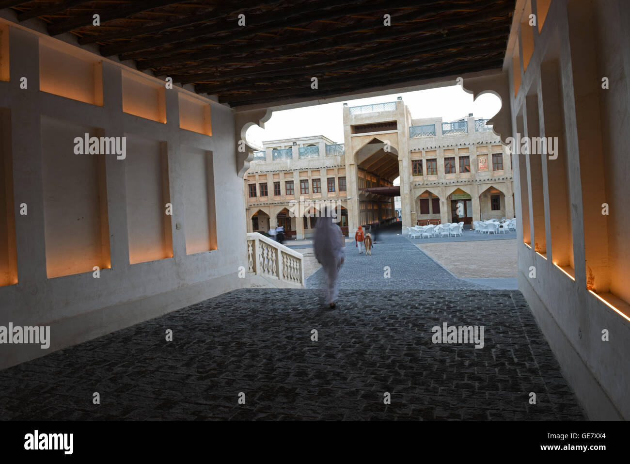 Qatari man walking at souq waqif Stock Photo - Alamy