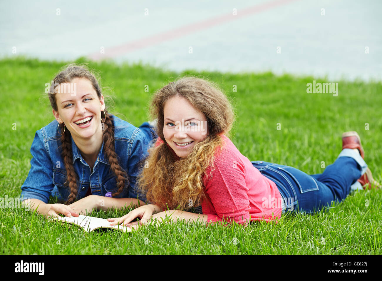 School girl reading book grass teen hi-res stock photography and images ...