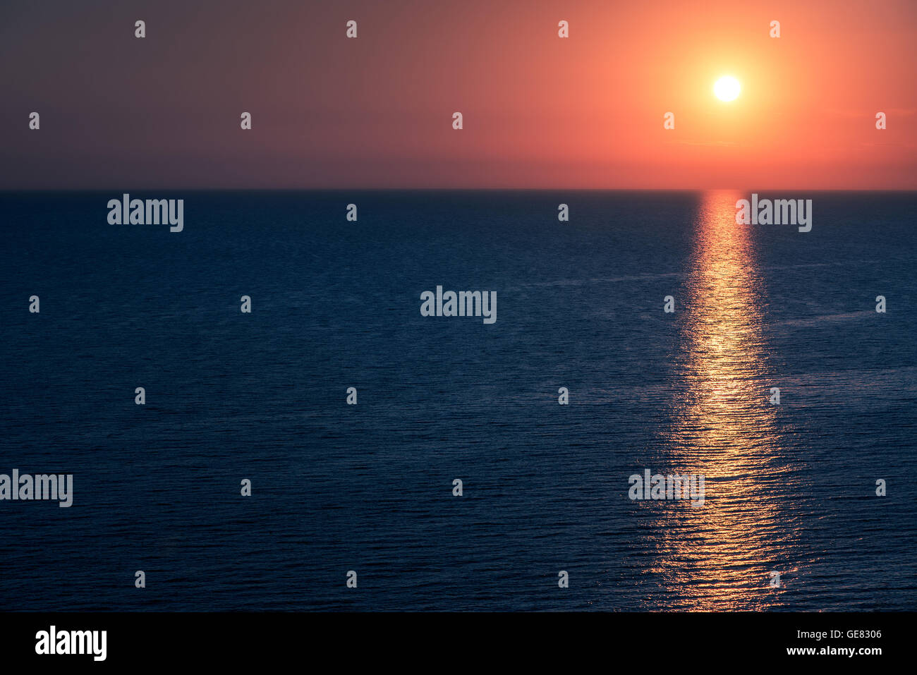 calm ocean at cloudless sunset Stock Photo - Alamy